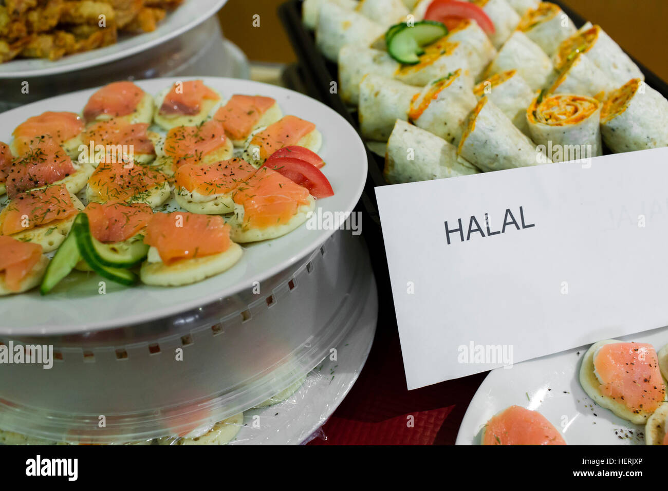 Trestle tables with plates full of buffet food lablled as halal adn ...