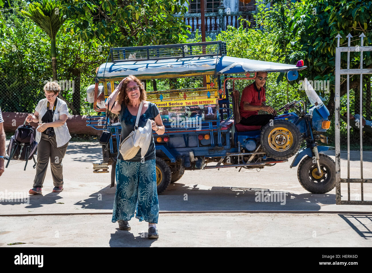Tourists and Tuk-Tuk taxi at Vang Vieng on the Nam Song River Stock ...