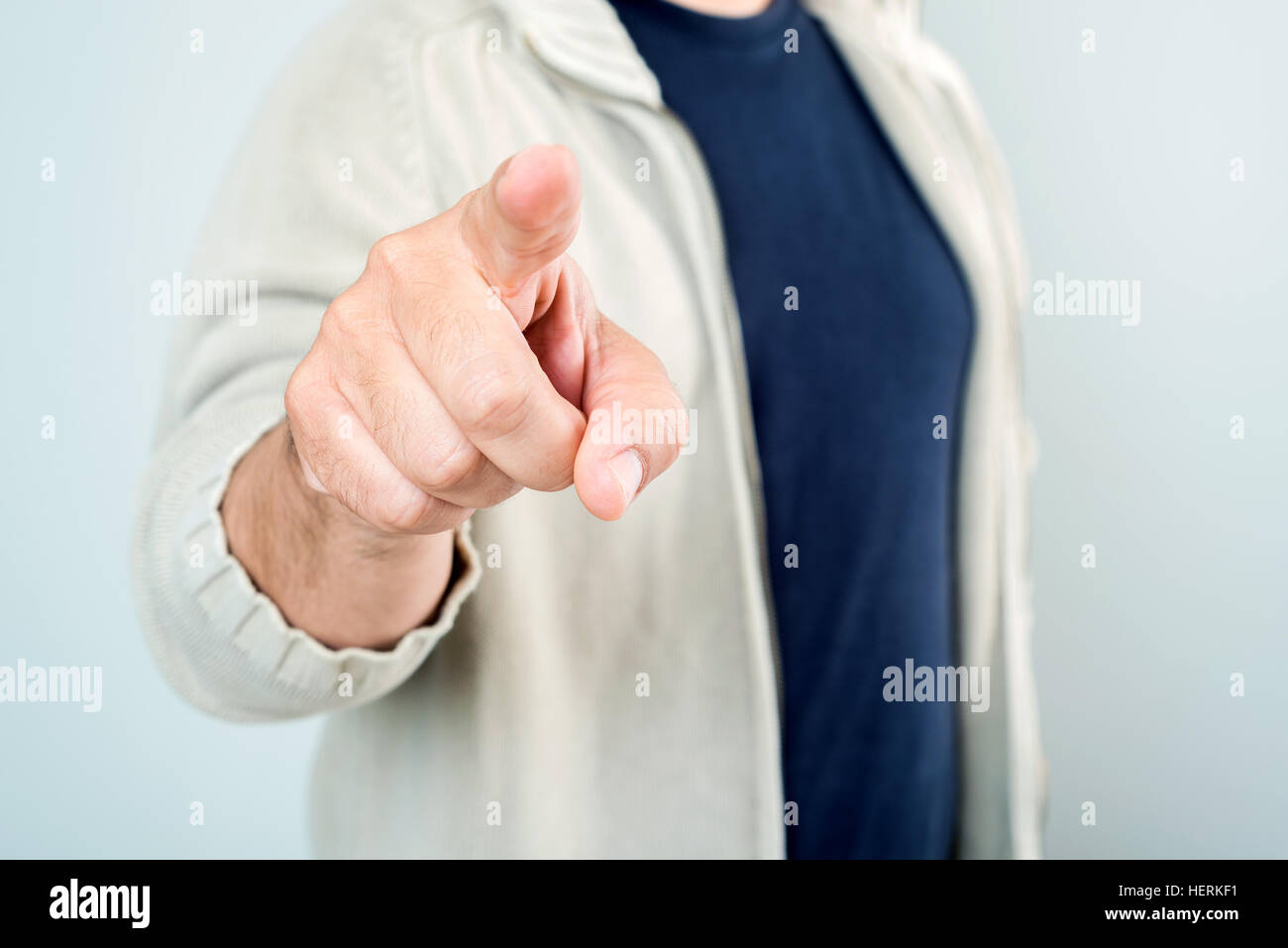 Casual young man pointing a finger towards camera Stock Photo - Alamy