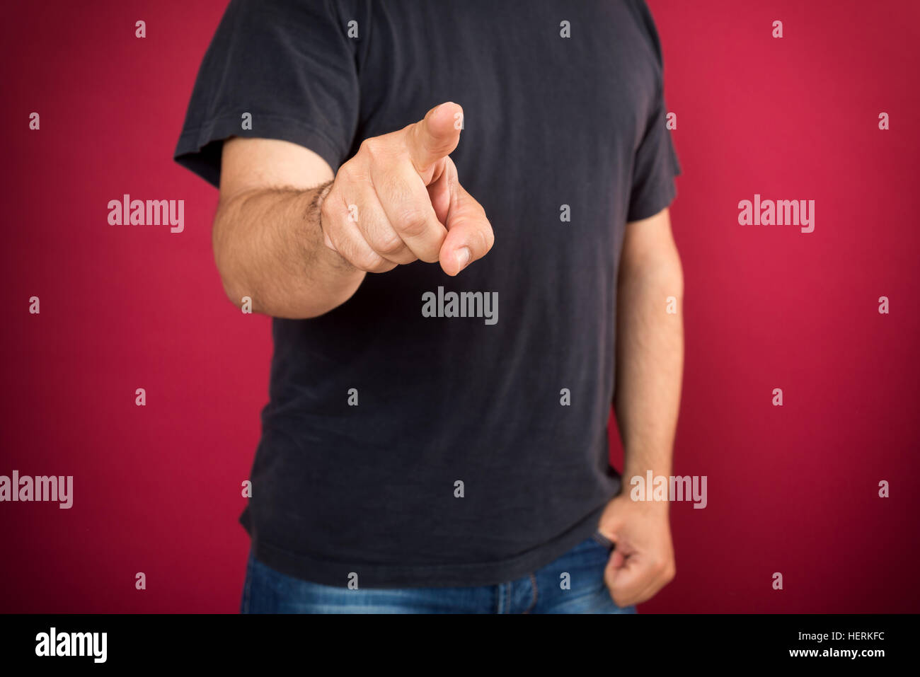Casual young man pointing a finger towards camera Stock Photo - Alamy