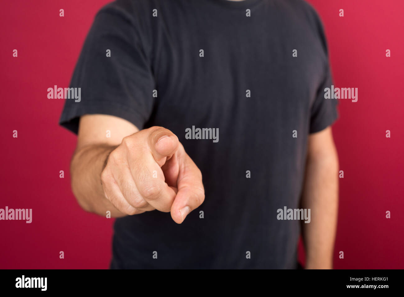 Casual young man pointing a finger towards camera Stock Photo - Alamy