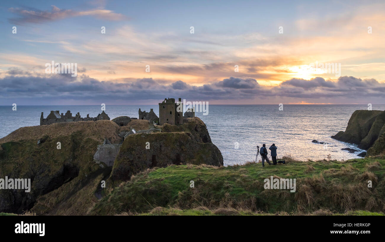 Two photographers capture a winter sunrise over Dunnottar Castle, near ...