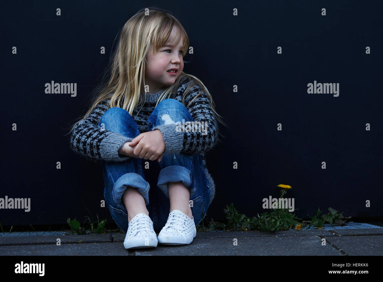 Girl hugging her knees Stock Photo - Alamy