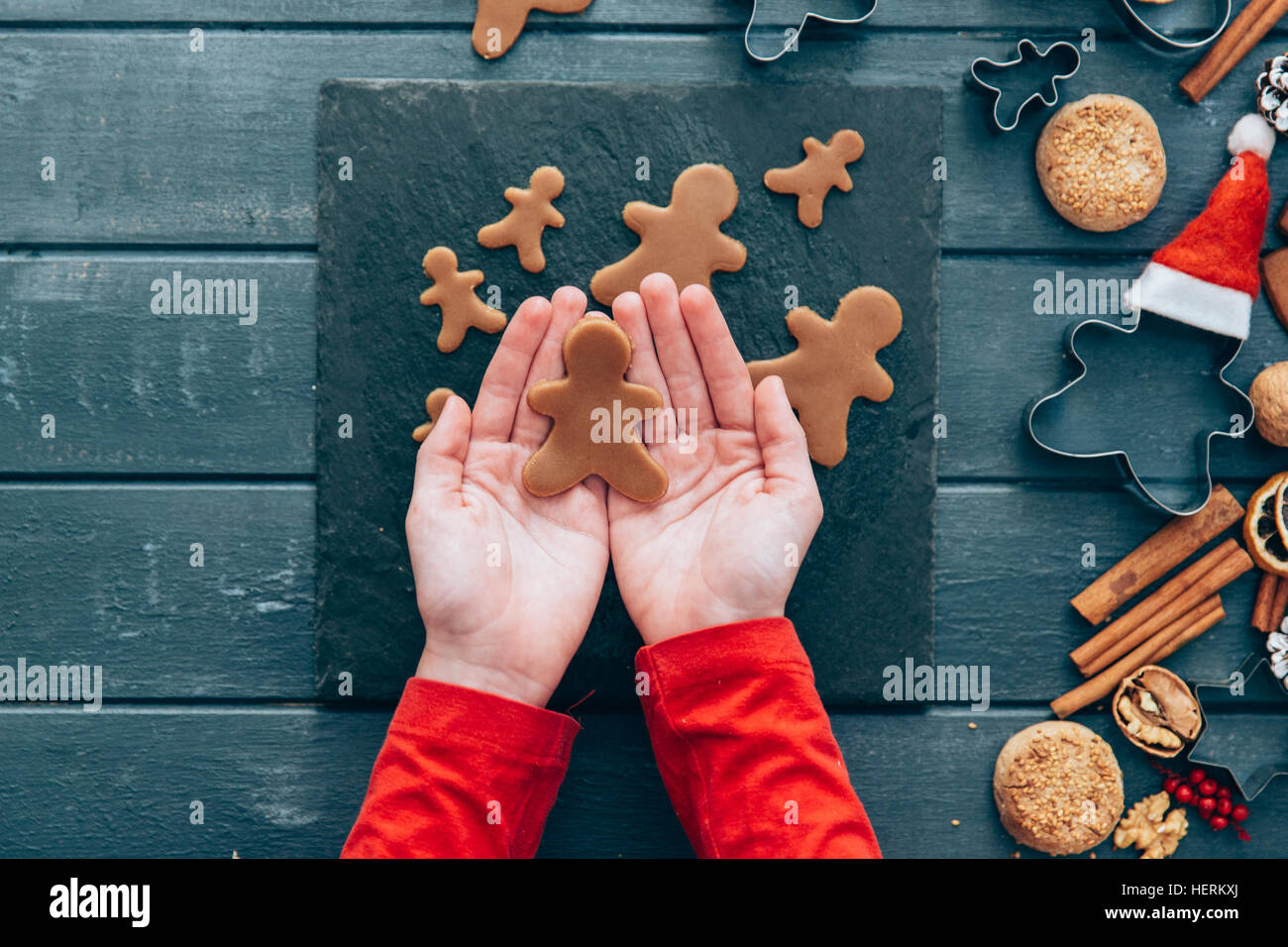 Girl holding gingerbread man Stock Photo - Alamy