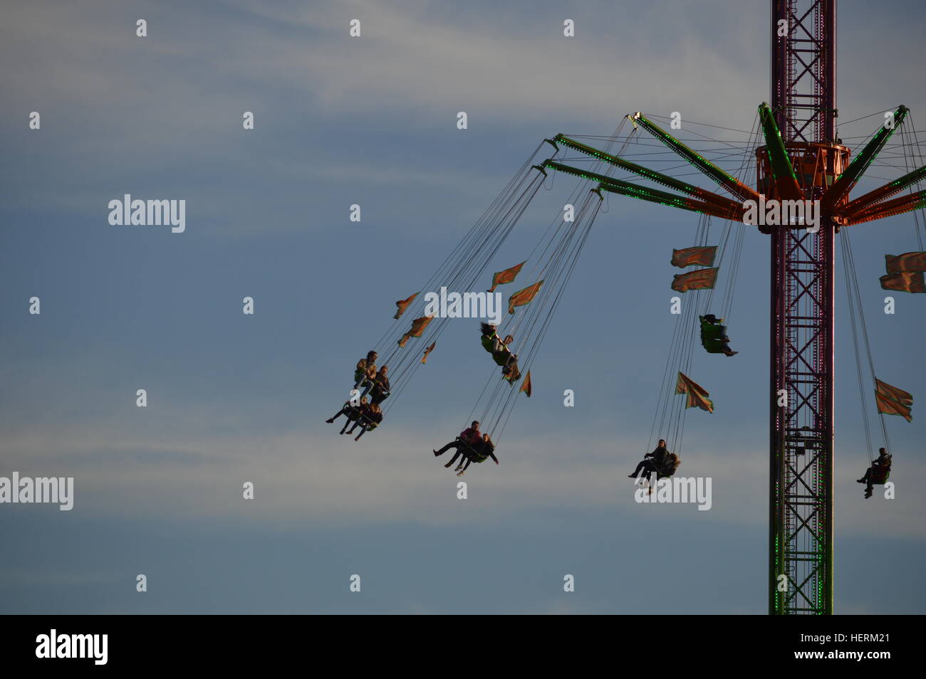 People high up on a swing ride Stock Photo - Alamy
