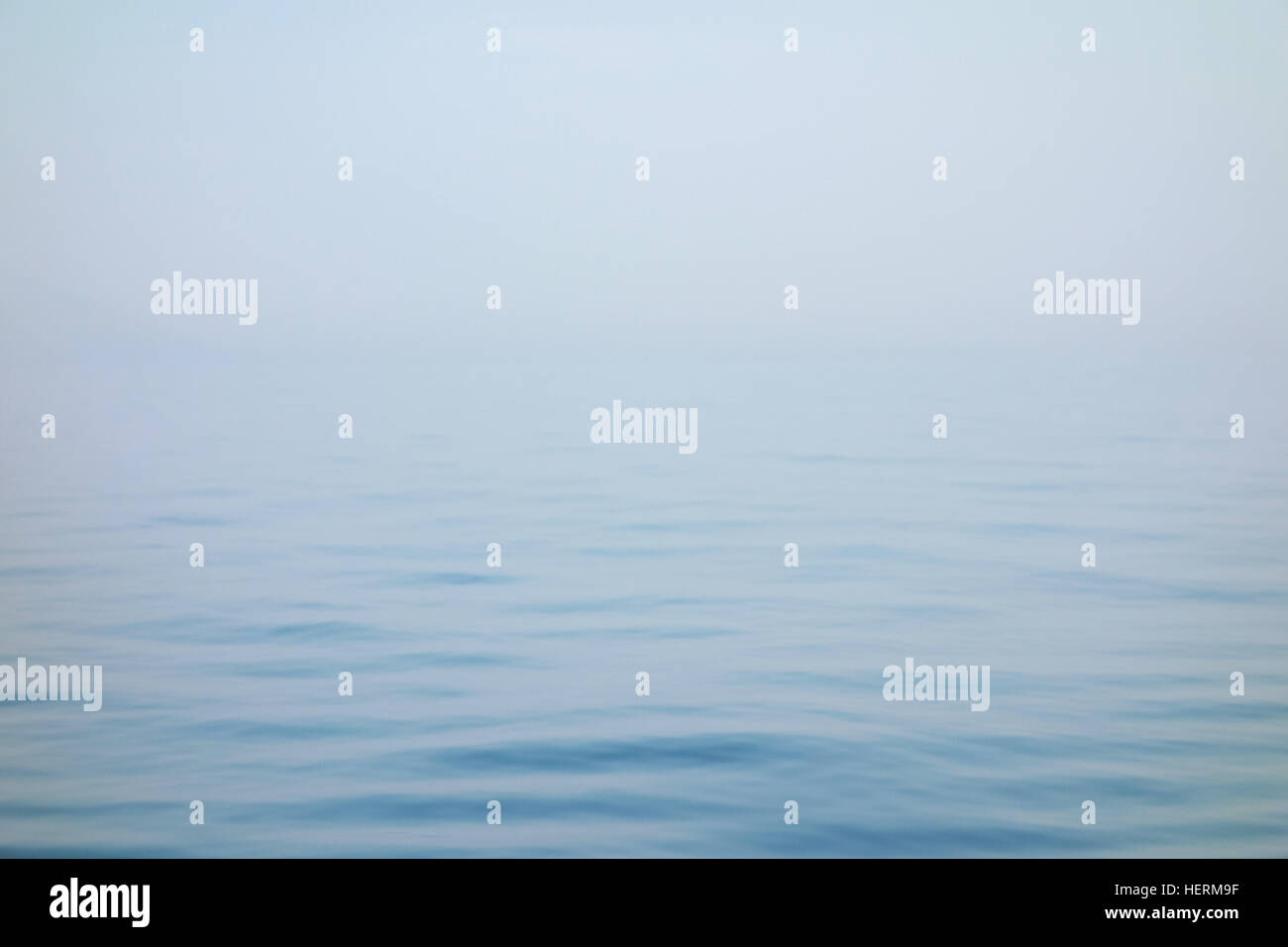 Blue sea fading into the horizon Stock Photo - Alamy