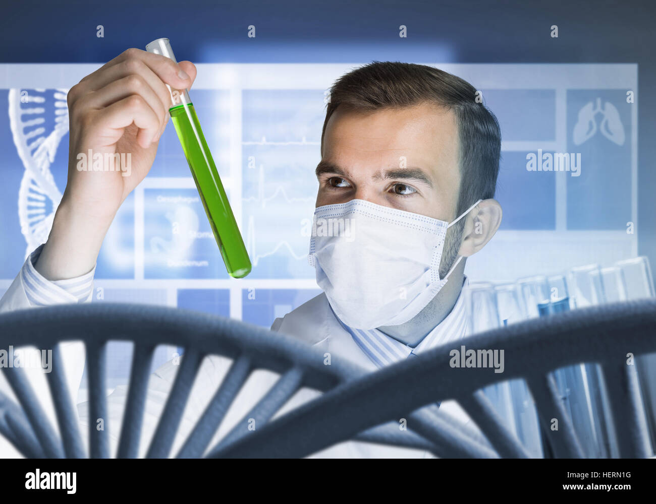 Young scientist mixing reagents in glass flask in clinical laboratory ...