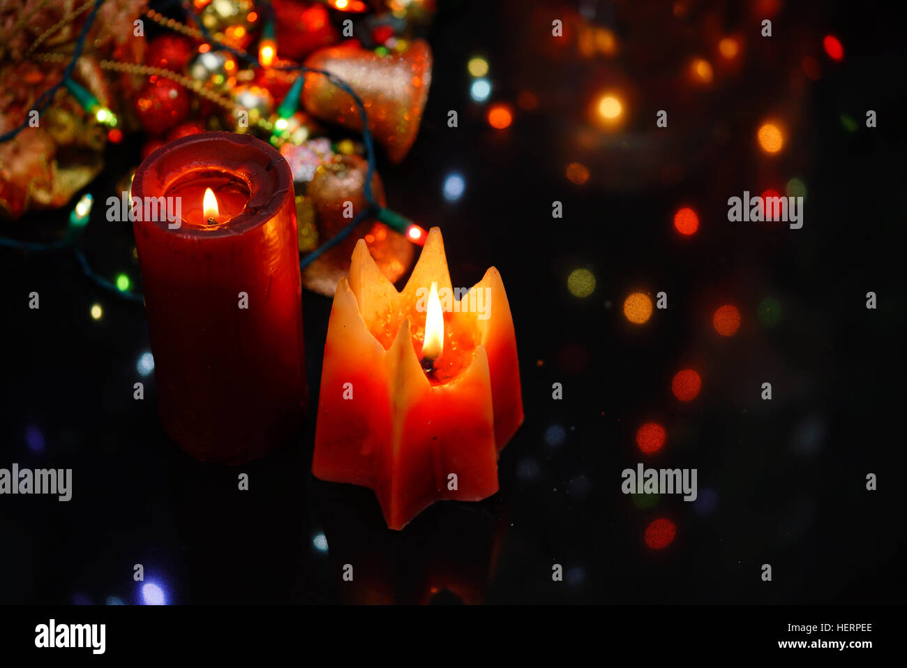 Candles and multi coloured Christmas fairy lights Stock Photo - Alamy