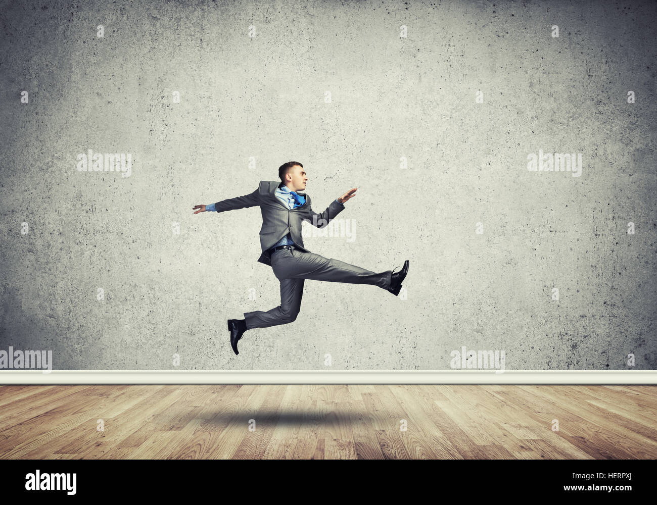 Businessman jumping high Stock Photo - Alamy