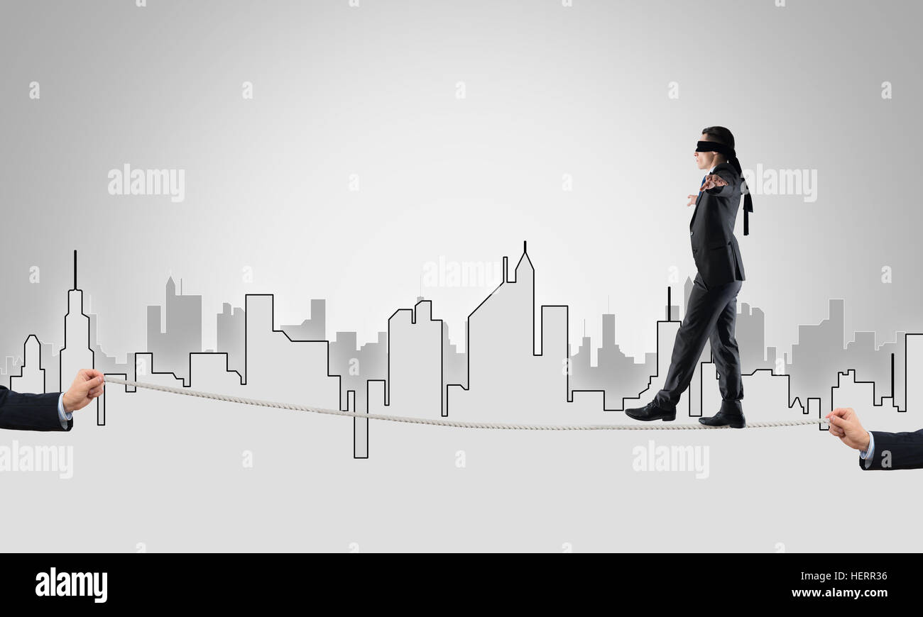 Business concept of risk support and assistance with man balancing on ...