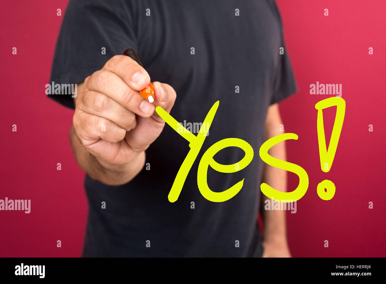 Young casual man writing the word YES on glass board with marker Stock ...