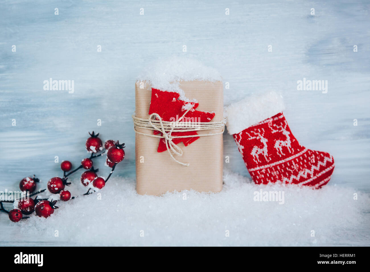 Christmas gift and stocking with red berries Stock Photo - Alamy