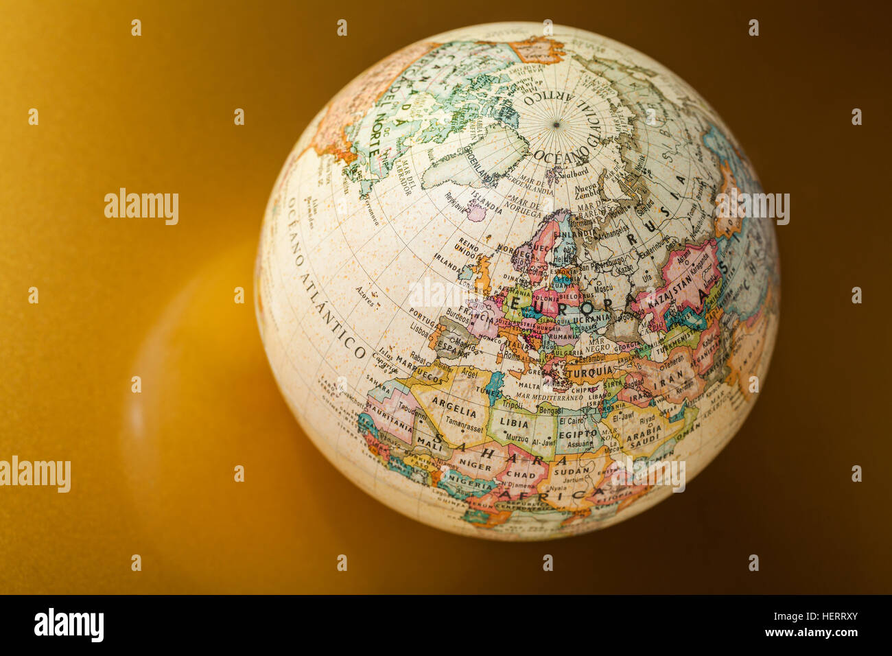 Old fashioned globe on golden background Stock Photo - Alamy