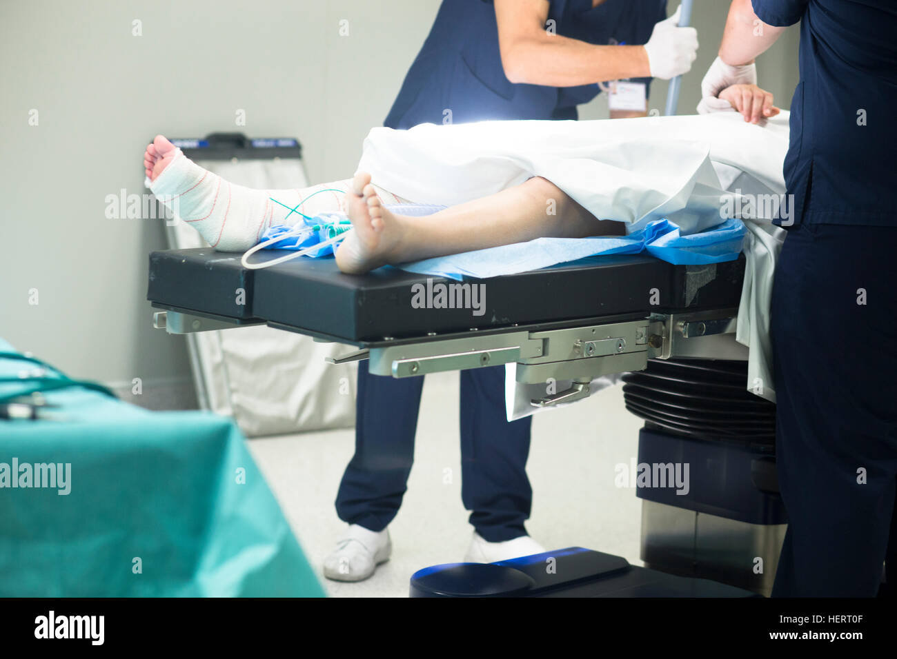 Hospital surgery bed and patient with leg bandaged post operation in ...