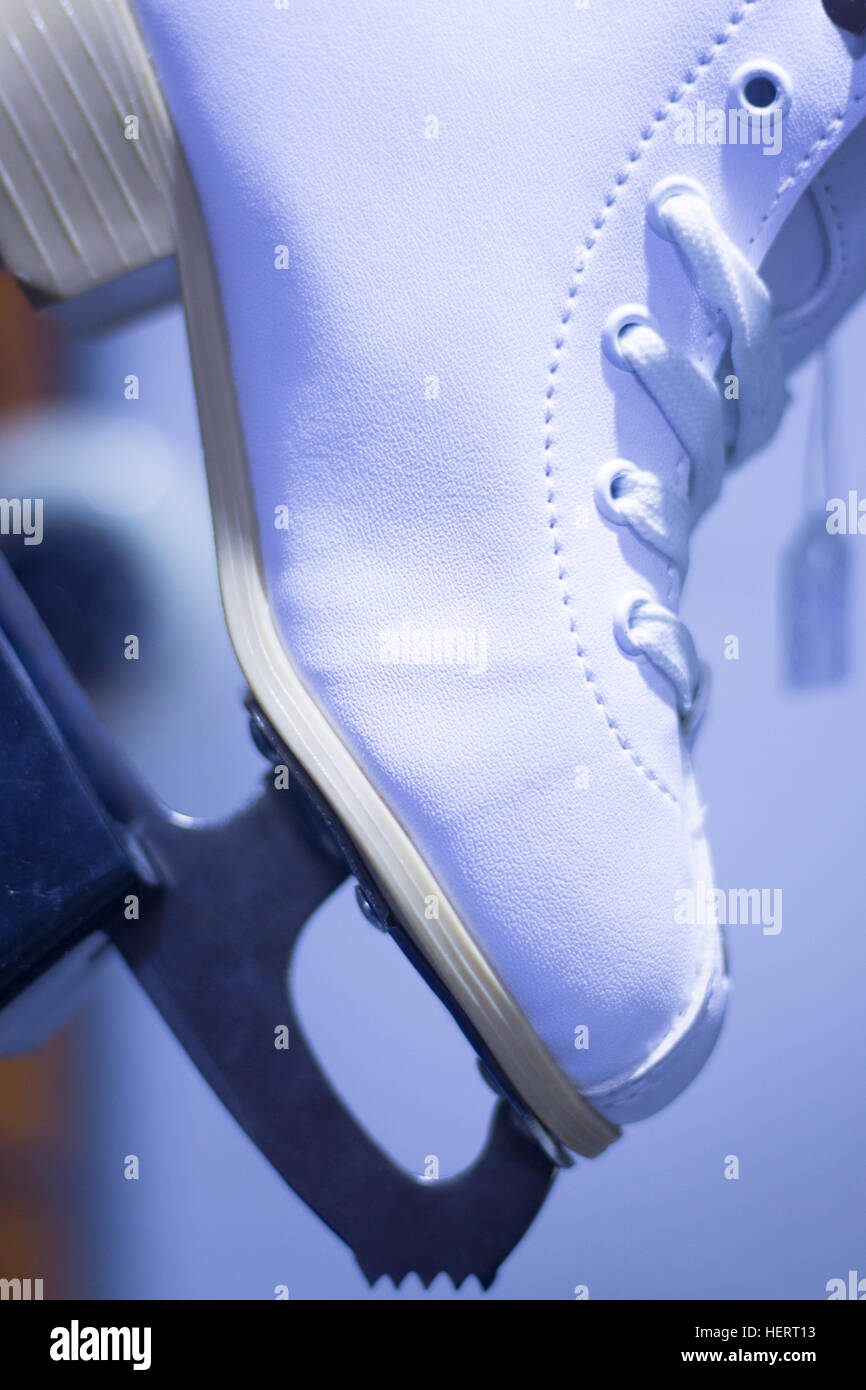 Ice skates in skate store shop window on display on sale for skating on ...