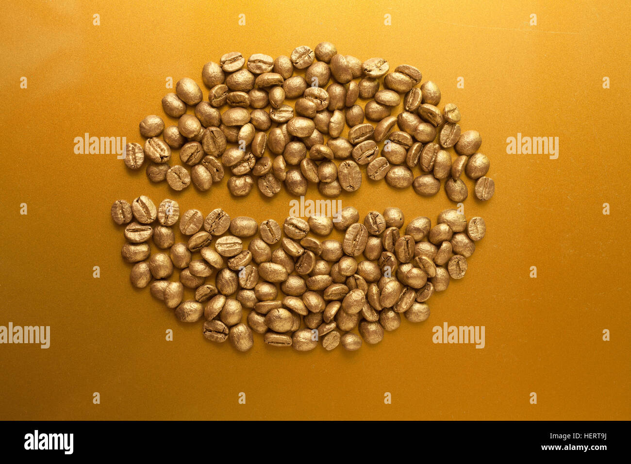 Gold coffee bean made of golden beans on gold background Stock Photo ...