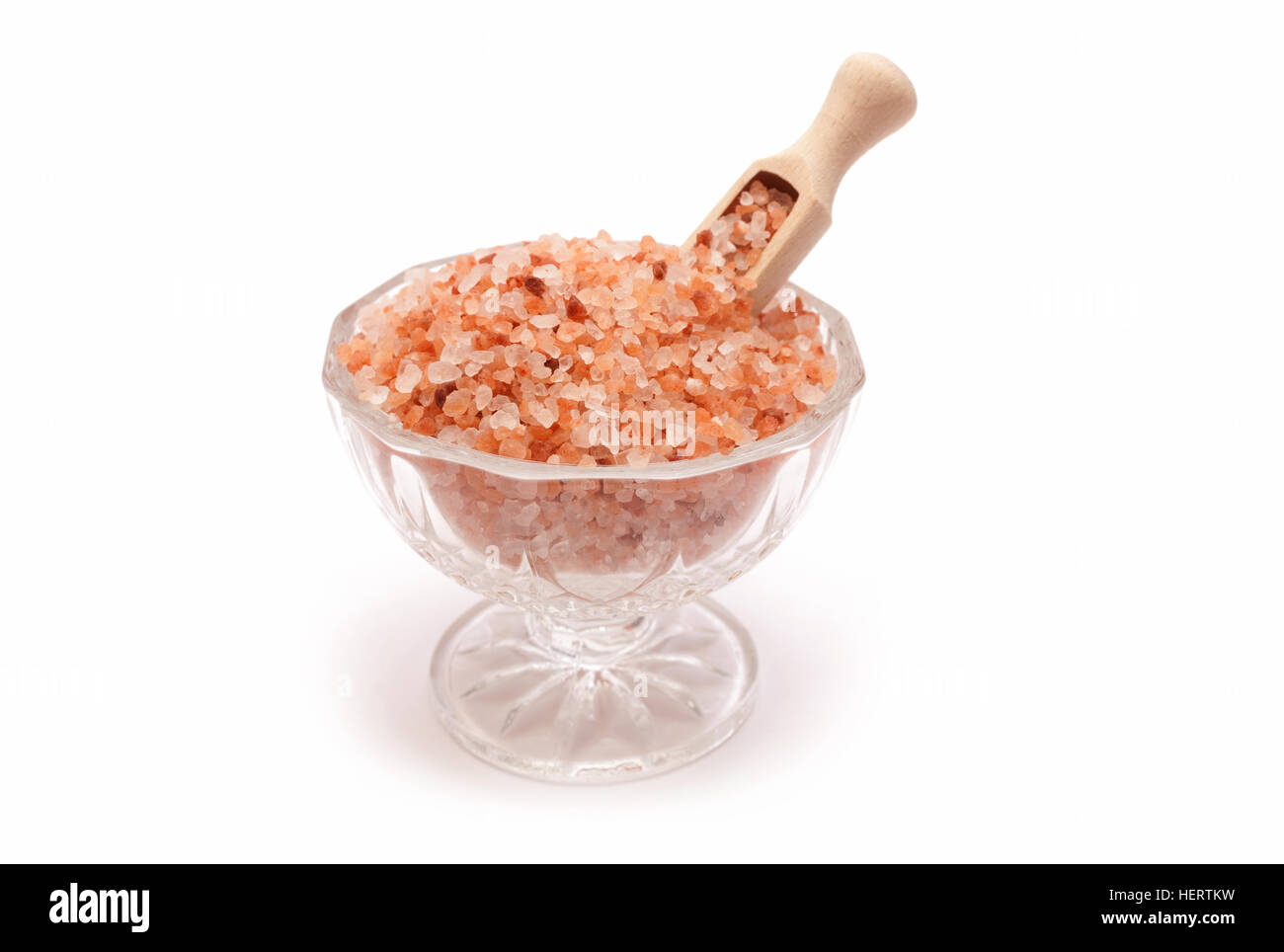 Himalayan salt in glass bowl with wooden scoop on white background ...