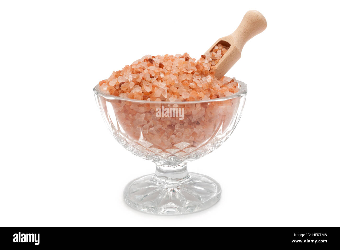 Himalayan salt in glass bowl with wooden scoop on white background ...