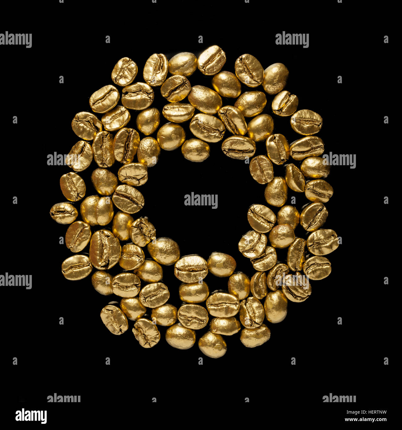 Golden cafe - coffee beans on black background Stock Photo - Alamy