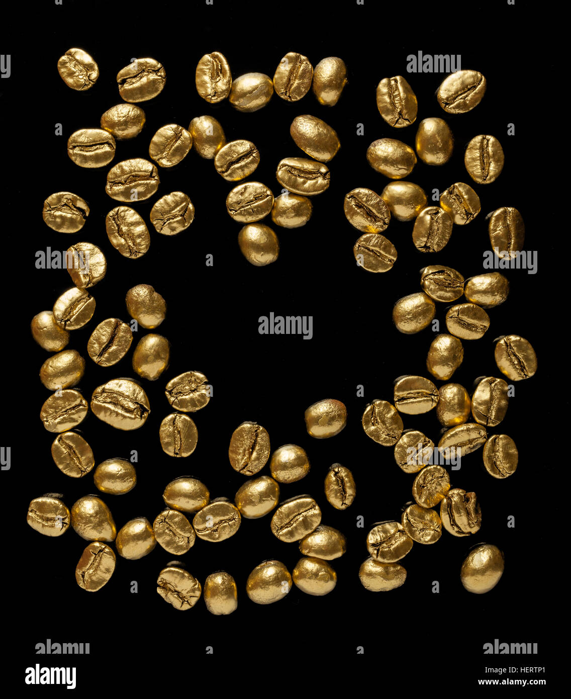 Golden cafe - coffee beans on black background Stock Photo - Alamy