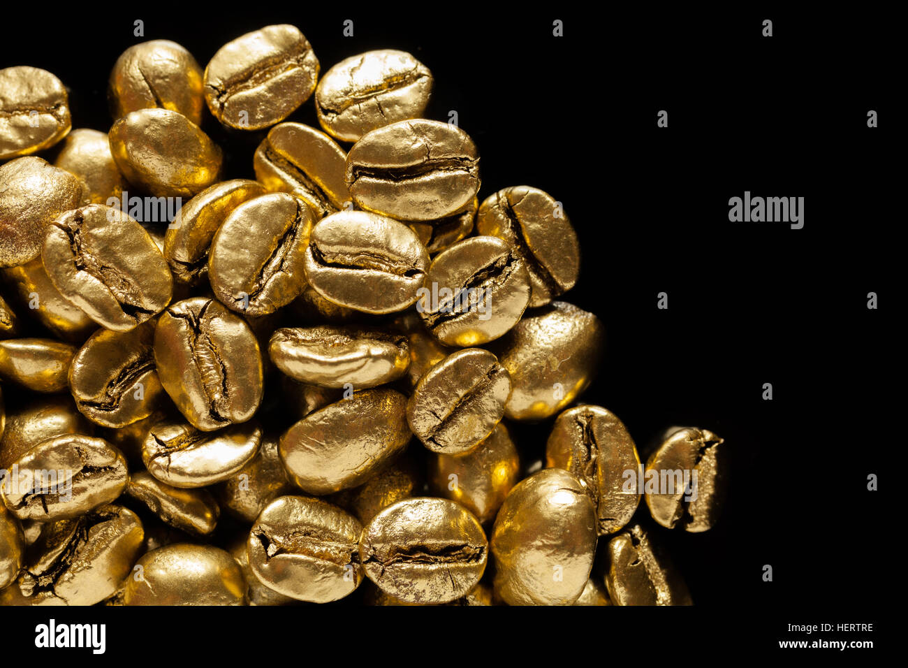 Golden cafe - coffee beans on black background Stock Photo - Alamy