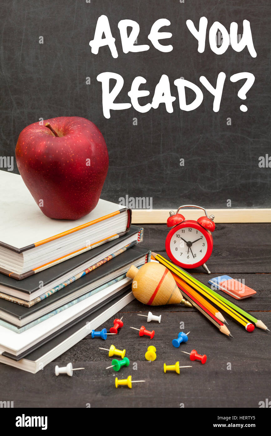 Apple on books and Are you ready? handwritten on the chalkboard in the ...