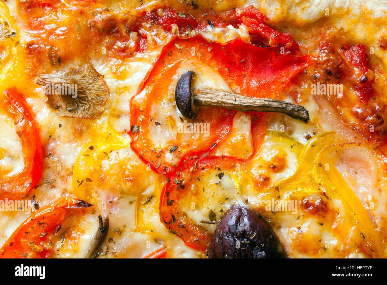 Close up photo of the surface of homemade pizza with mushrooms, tomato ...