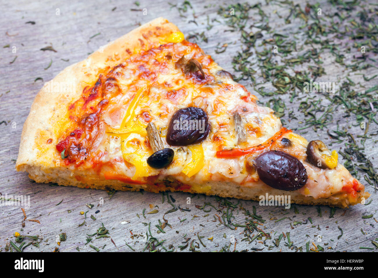 Cut off home made pizza slice on wooden rustic background Stock Photo ...
