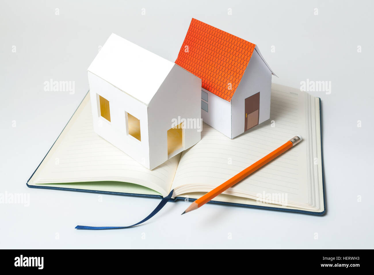 Requirements of the house. Paper house on memorandum block Stock Photo ...
