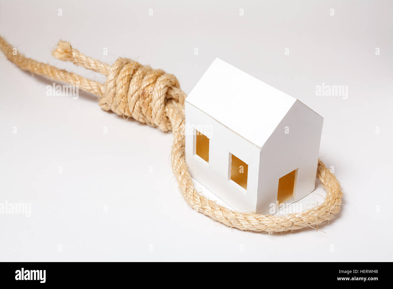 Small house with hangman's noose on white background Stock Photo - Alamy