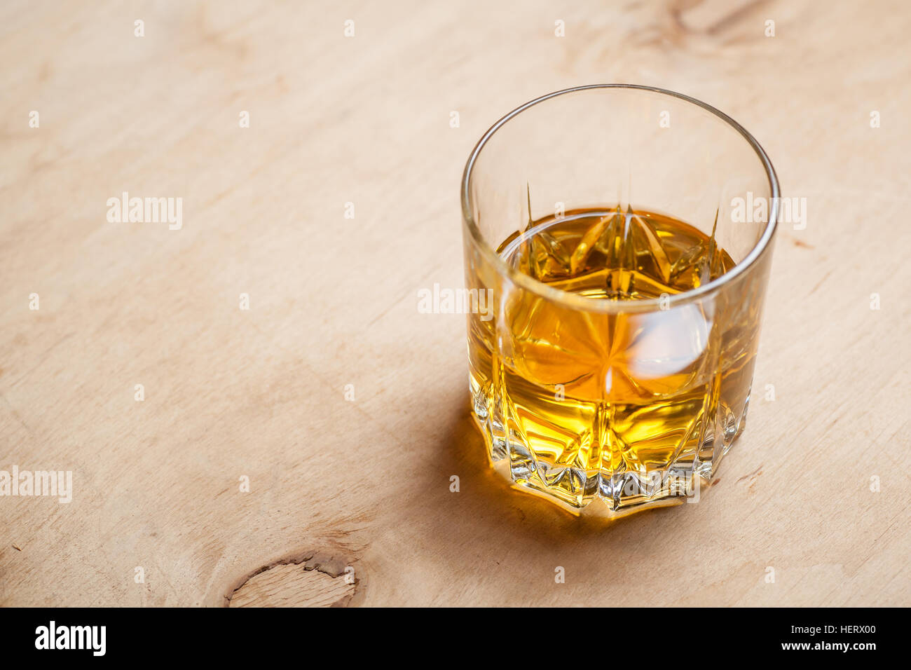 Glass of whiskey on a textured wooden surface Stock Photo - Alamy