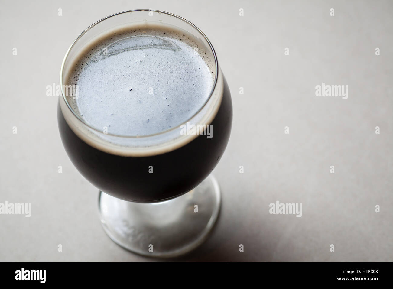 Small glass full of imperial stout ale on a gray table Stock Photo - Alamy