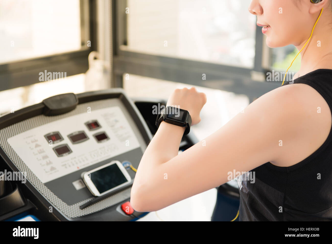 sport asian woman running treadmill use smartwatch check pulse rate ...