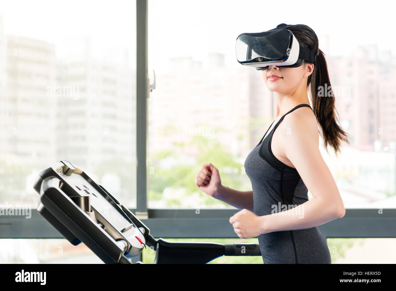 beauty asian woman running treadmill by virtual reality. VR headset ...