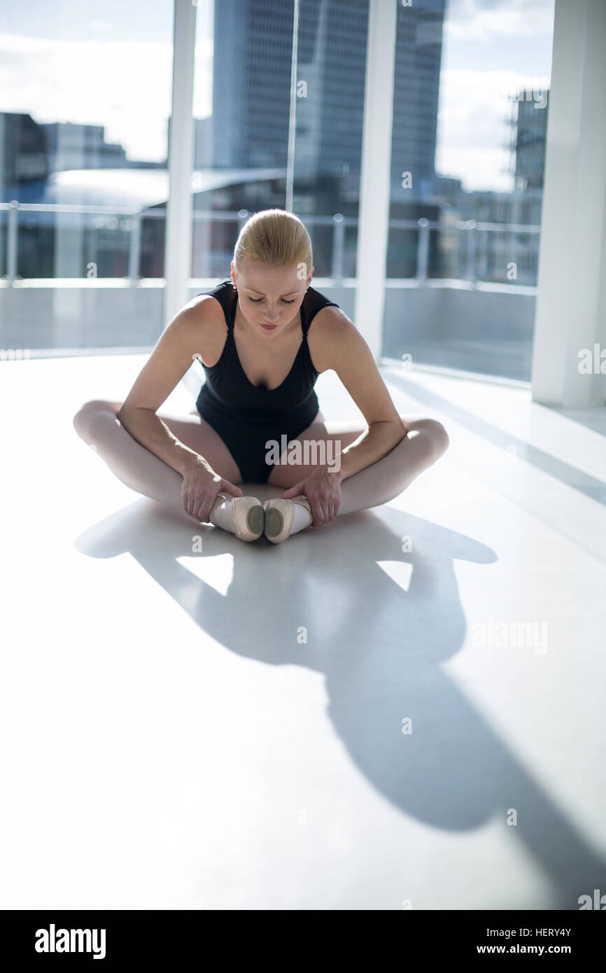 Ballerina performing a stretching exercise in the ballet studio Stock ...