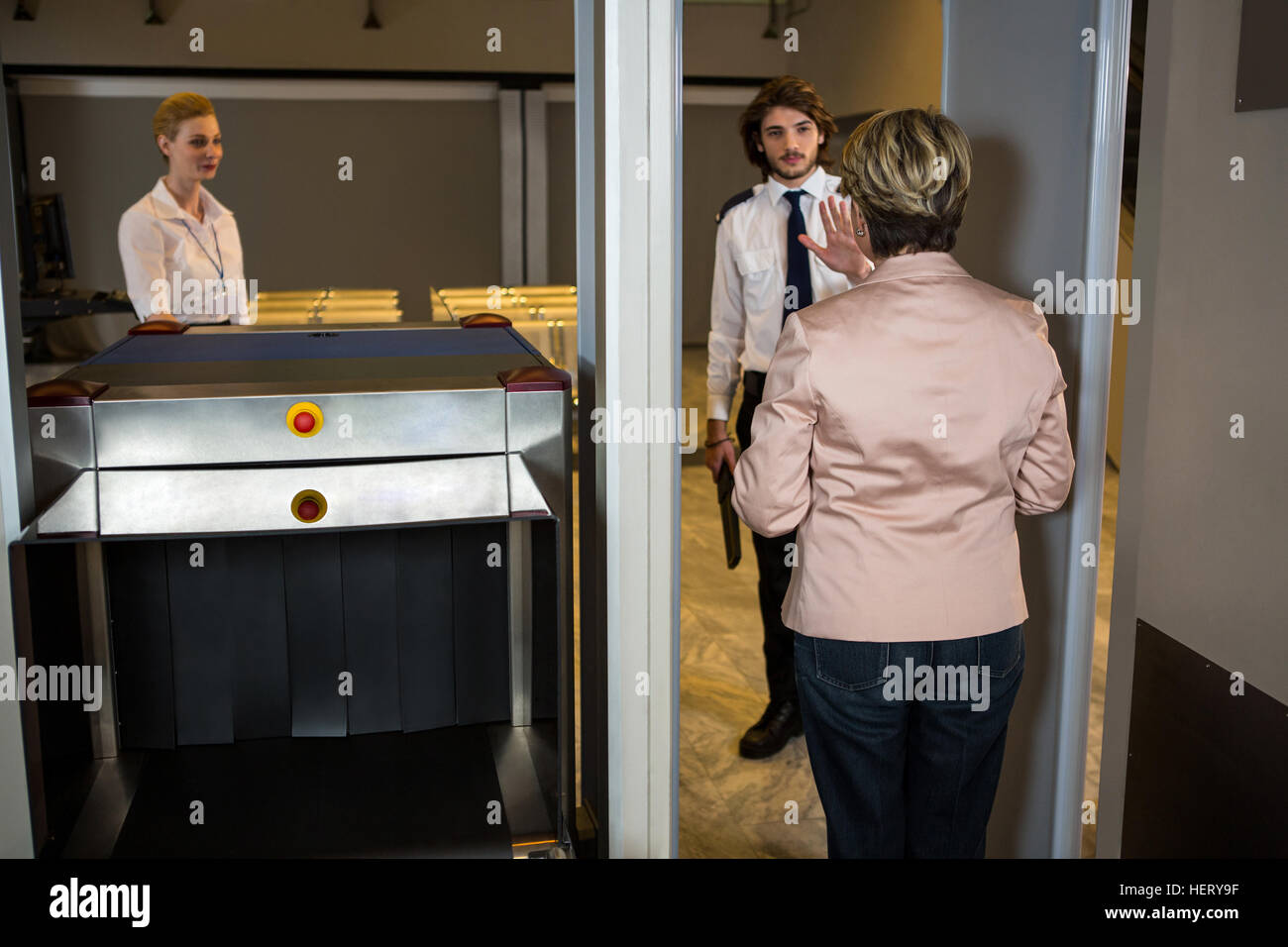 Security guard ask in the passenger to stop for the security check in ...
