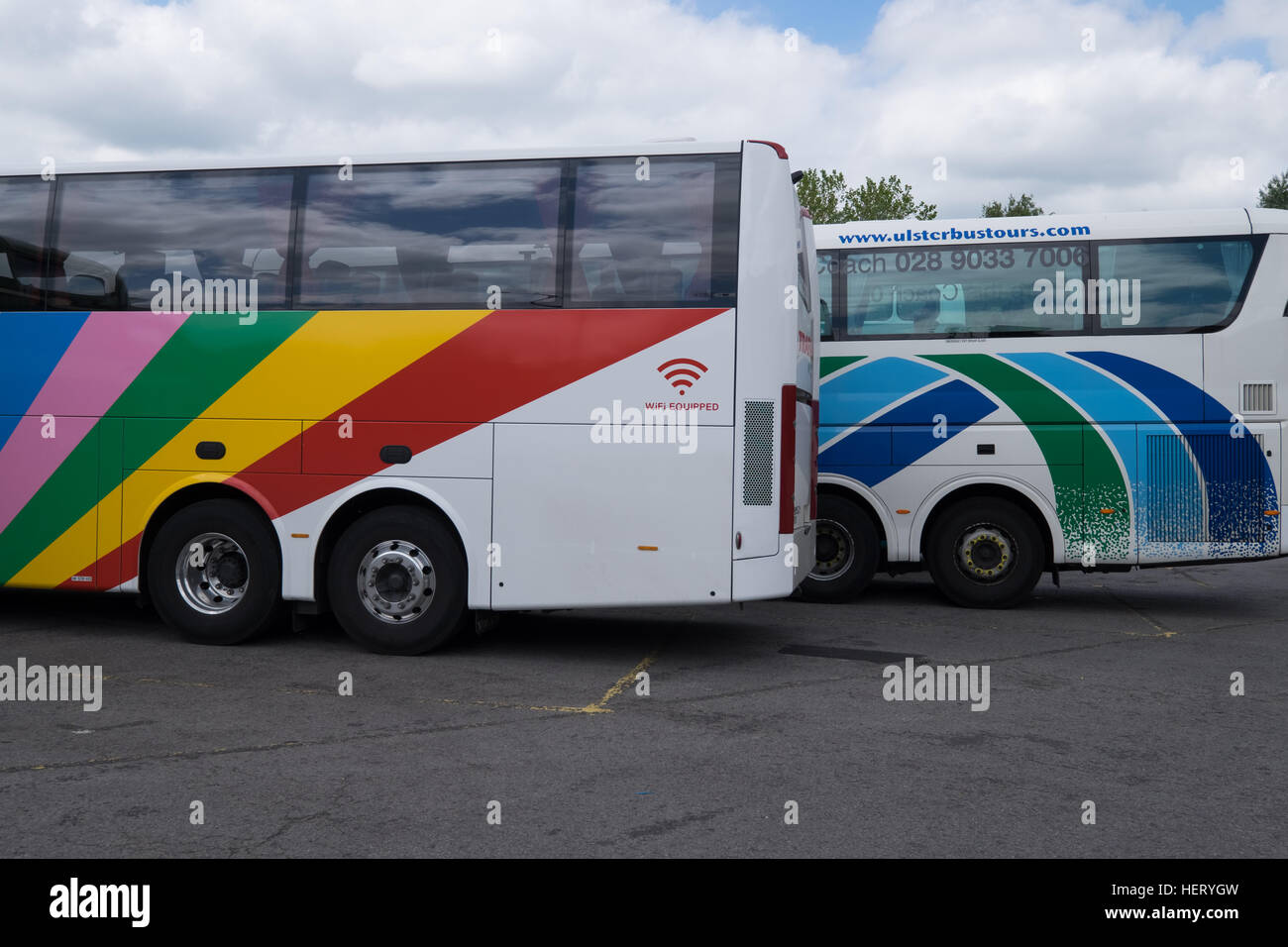 rear ends of two colourful coaches Stock Photo - Alamy