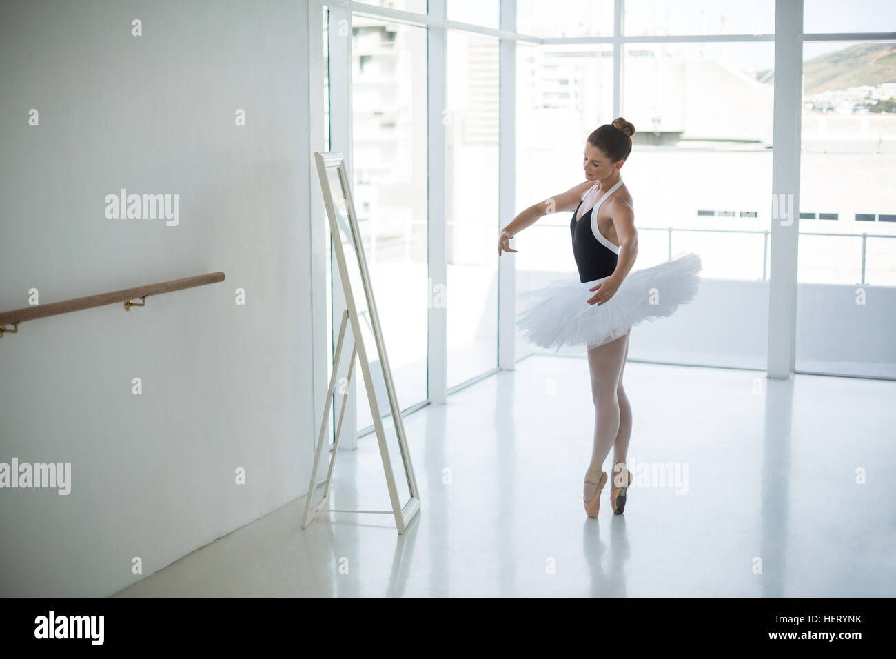 Ballerina practicing ballet dance in front of mirror in the studio ...
