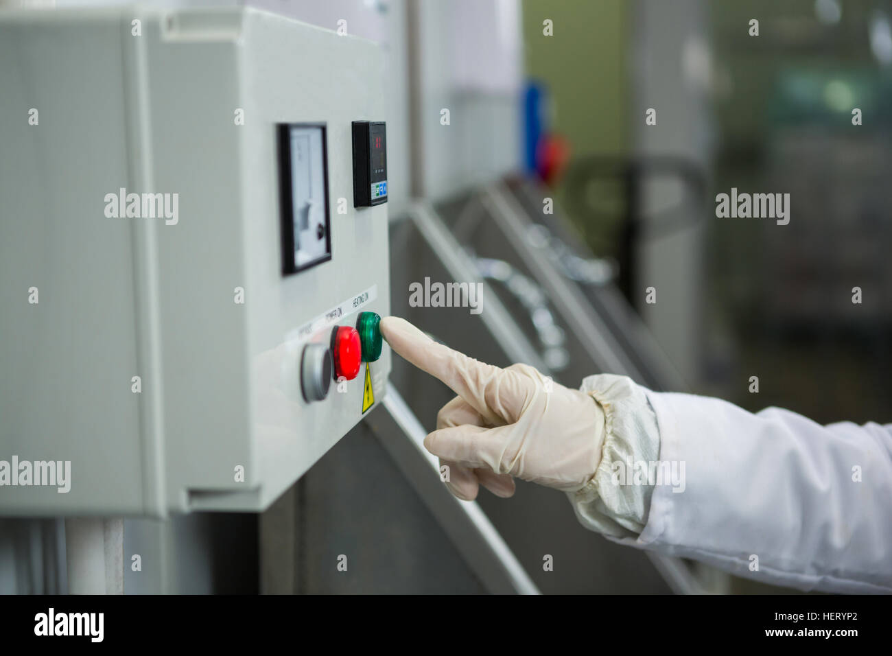 Close-up of butcher operating machine at meat factory Stock Photo - Alamy