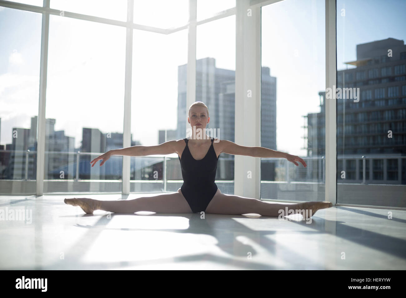 Ballerina doing stretching exercise in the ballet studio Stock Photo ...