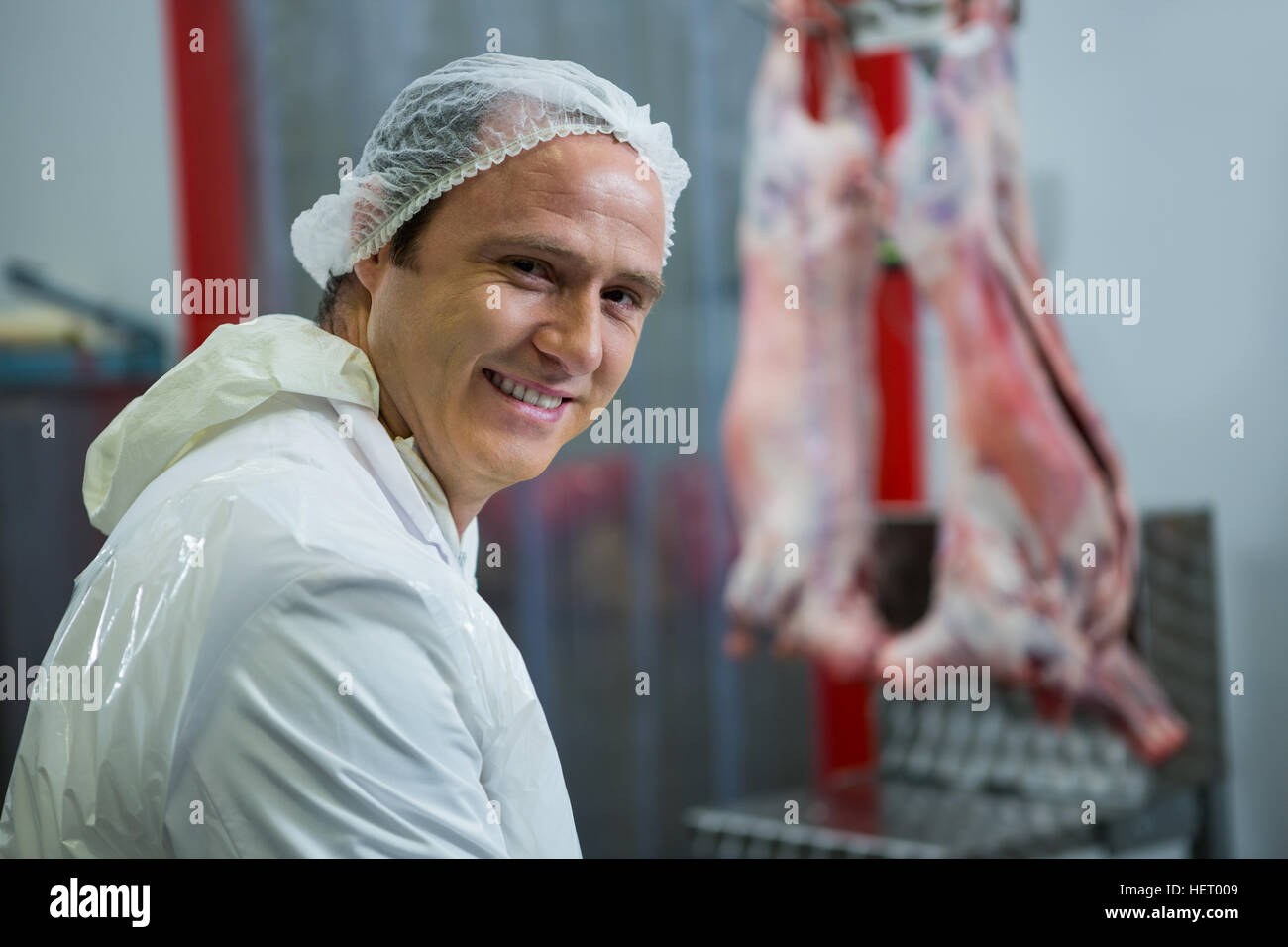 Portrait of smiling butcher at meat factory Stock Photo - Alamy