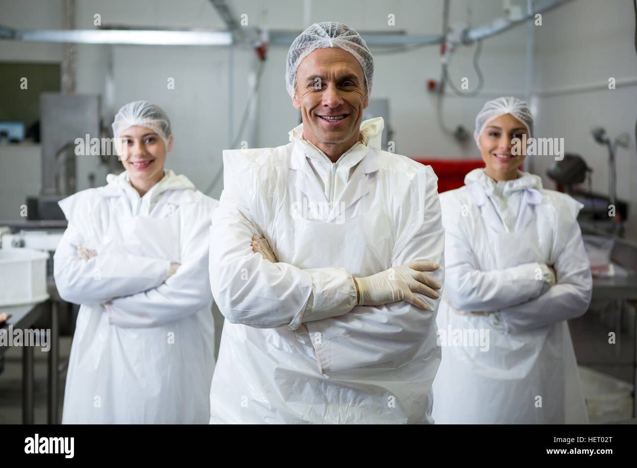 Butchers standing with arms crossed in meat factory Stock Photo - Alamy