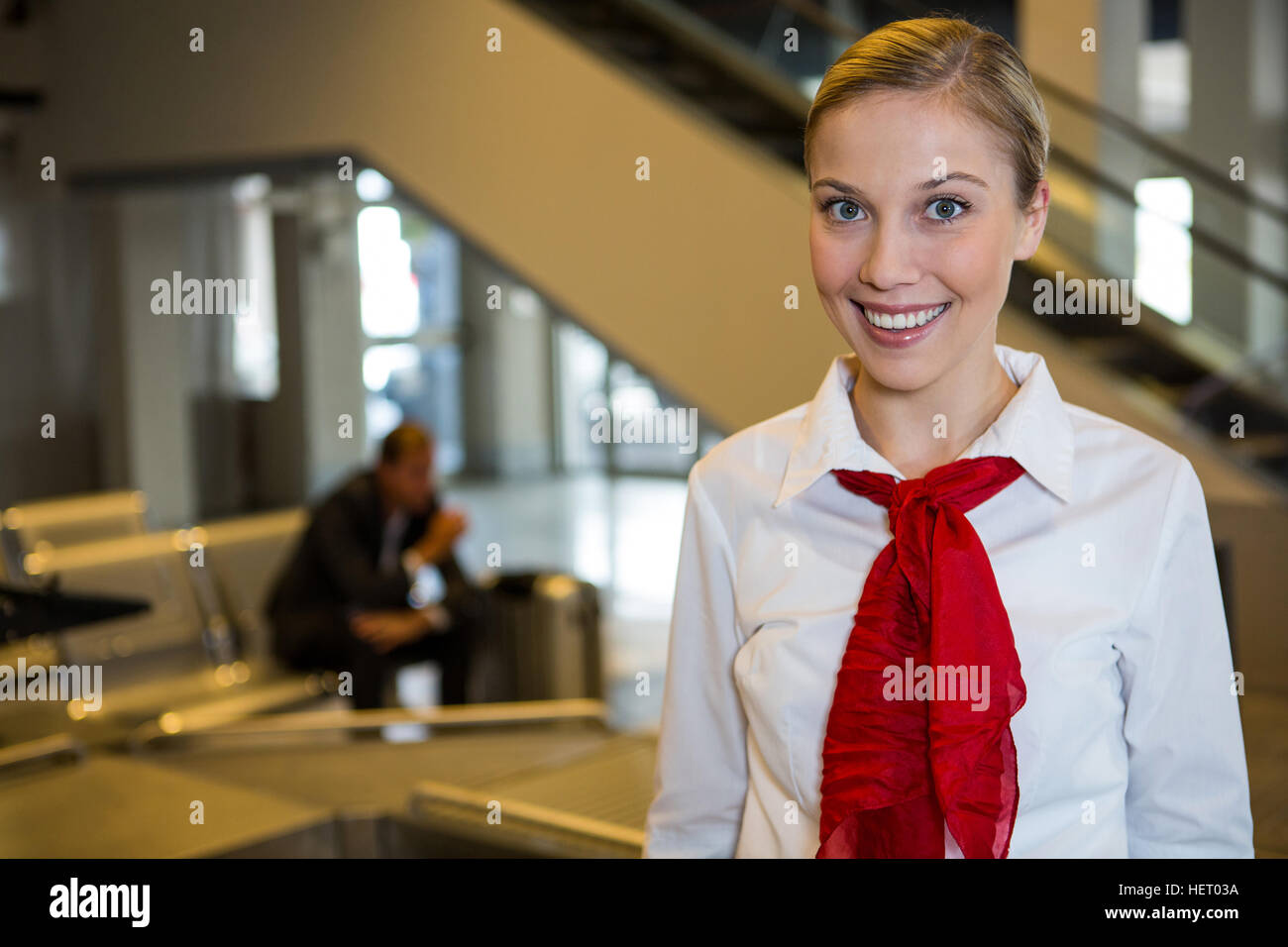 Portrait of smiling female staff at the airport terminal Stock Photo ...