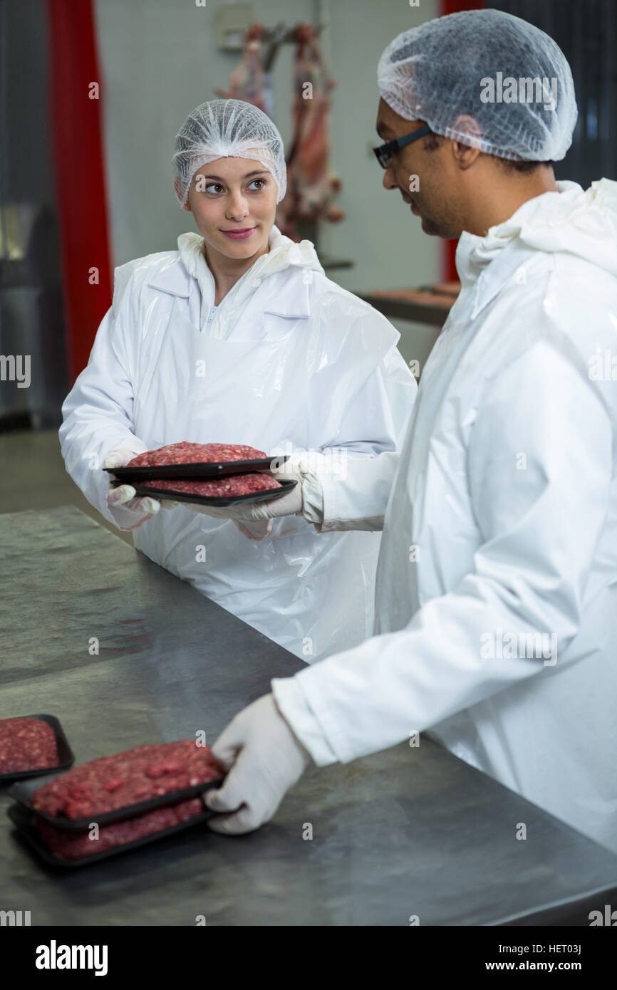 Butchers packaging minced meat at meat factory Stock Photo - Alamy
