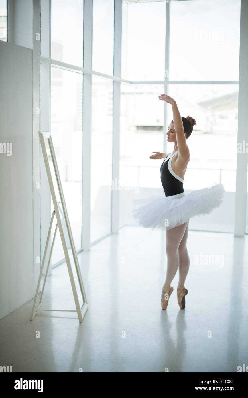 Ballerina practicing ballet dance in front of mirror in the studio ...