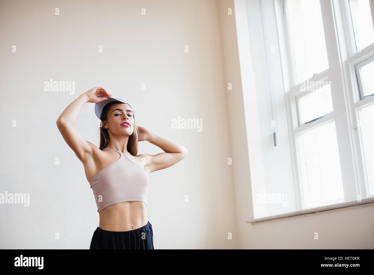 Portrait of a pretty woman standing in hip hop dance studio Stock Photo ...