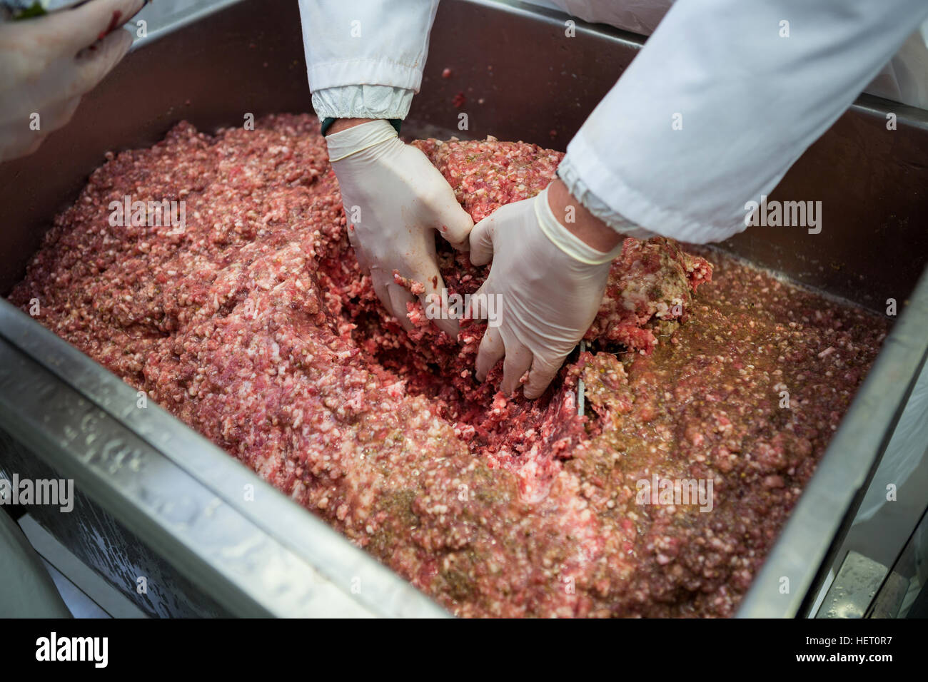 Close-up of hands of butcher mixing minced meat Stock Photo - Alamy