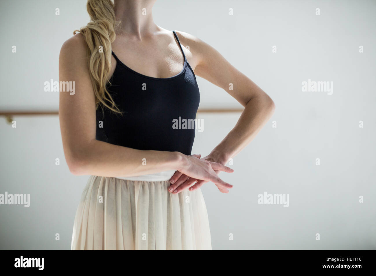 Mid section of ballerina practicing a ballet dance in ballet studio ...