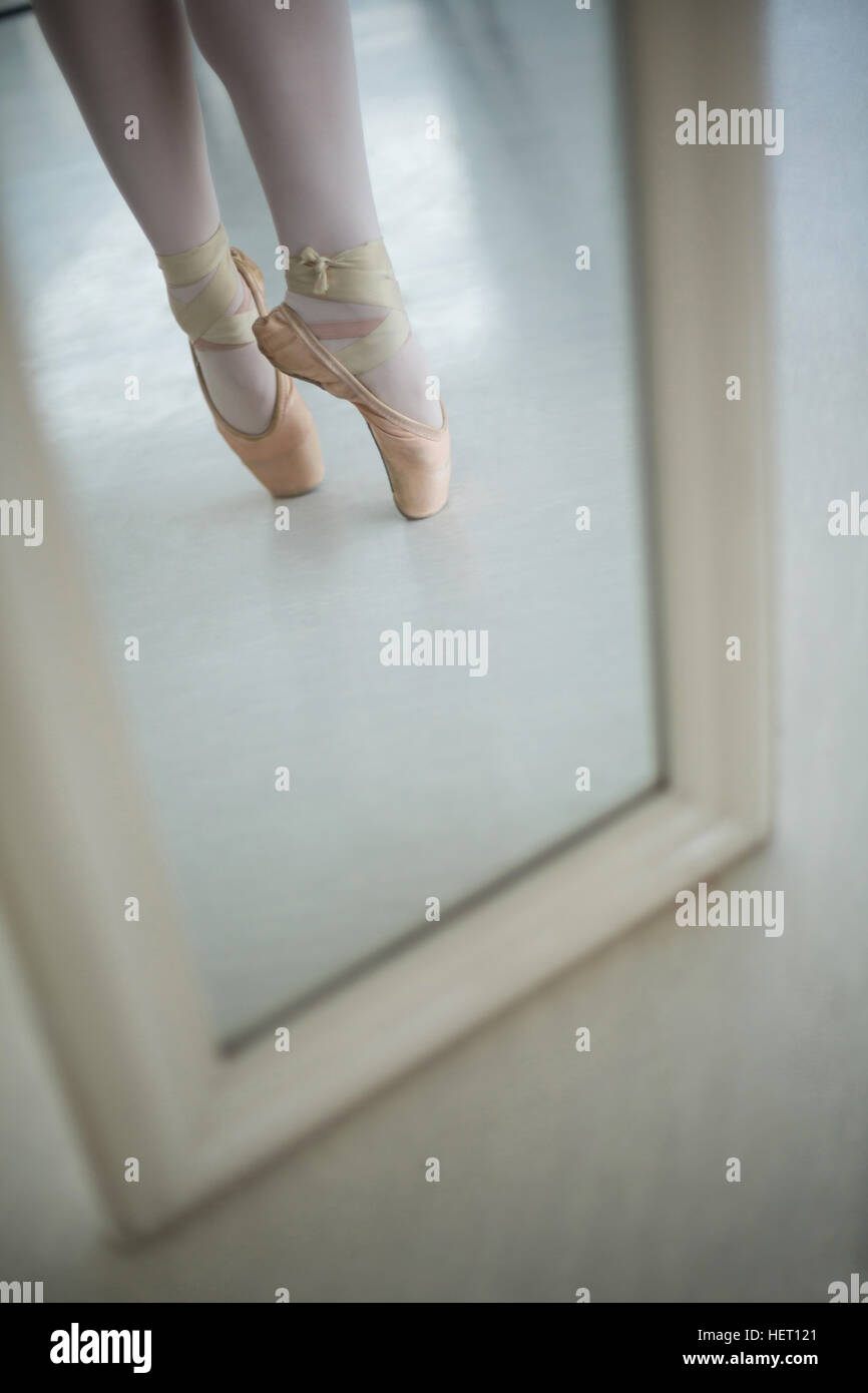 Reflection of ballerinas feet practicing ballet dance in the studio ...