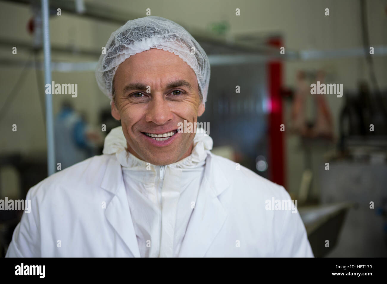 Portrait of smiling butcher at meat factory Stock Photo - Alamy